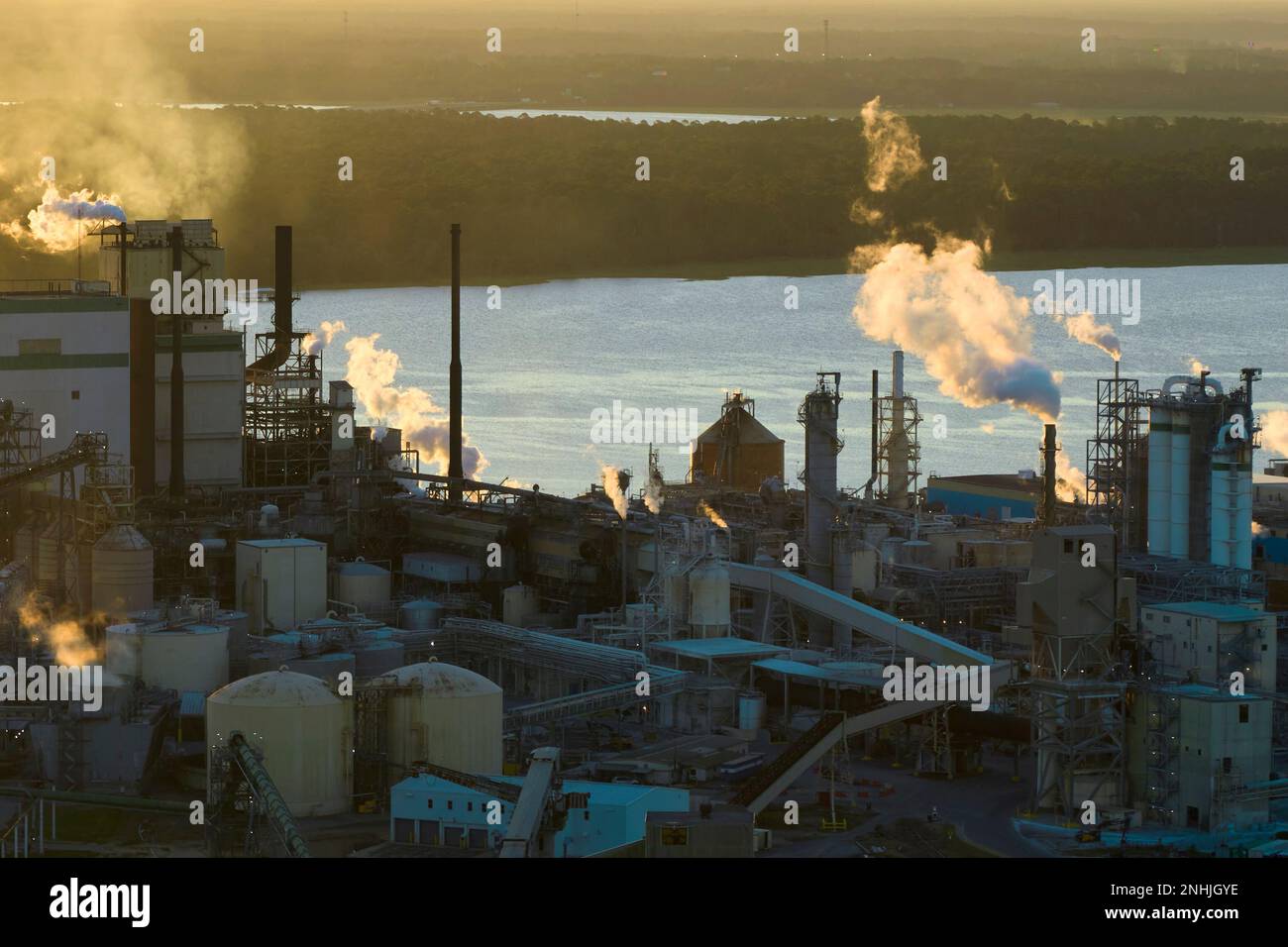 Aerial view of wood processing factory with smoke from production ...