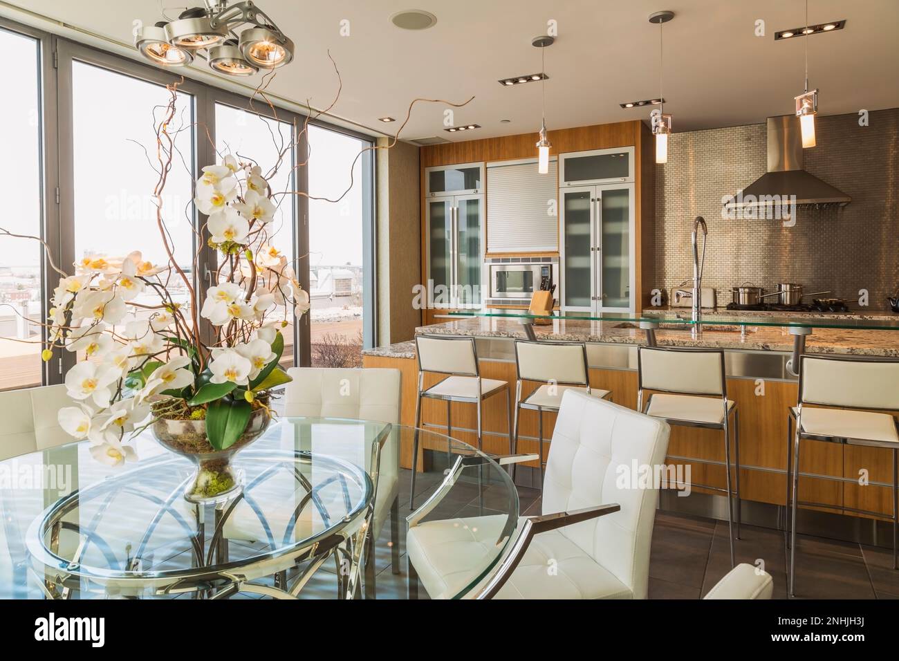 Round glass dining table with white leather chairs, wood and glass ...