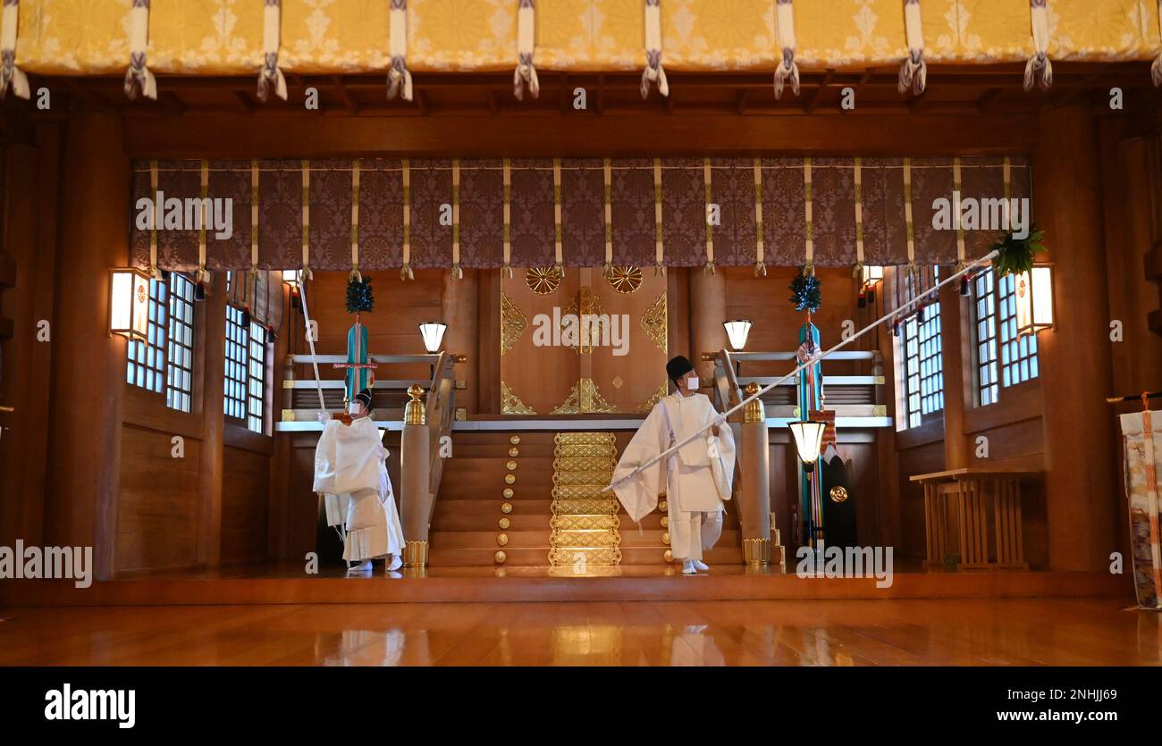 Kannushi, Shinto priest, wearing face masks perform a susuharai by ...