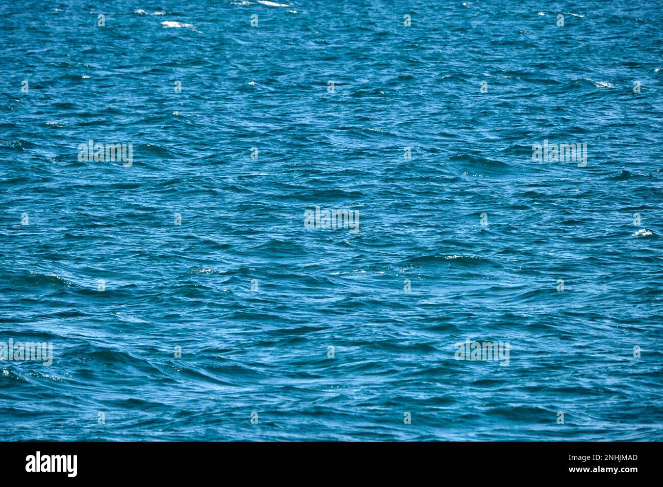 Closeup seascape surface of blue sea water with small ripple waves ...