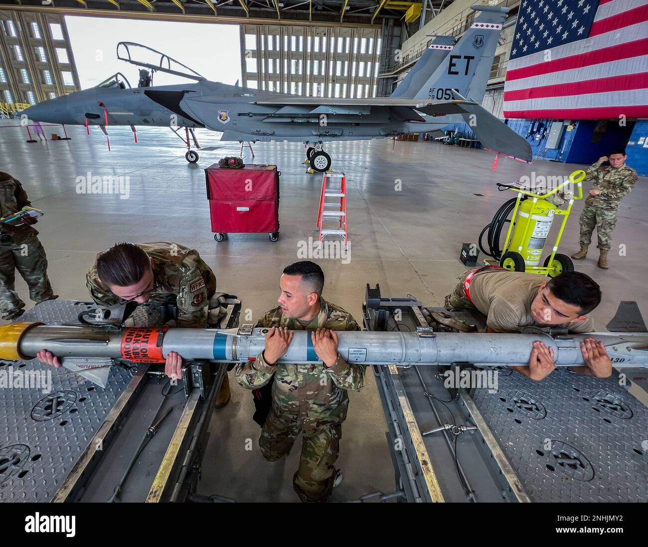 The 96th Aircraft Maintenance Squadron Red team pick up an AIM-9 onto ...