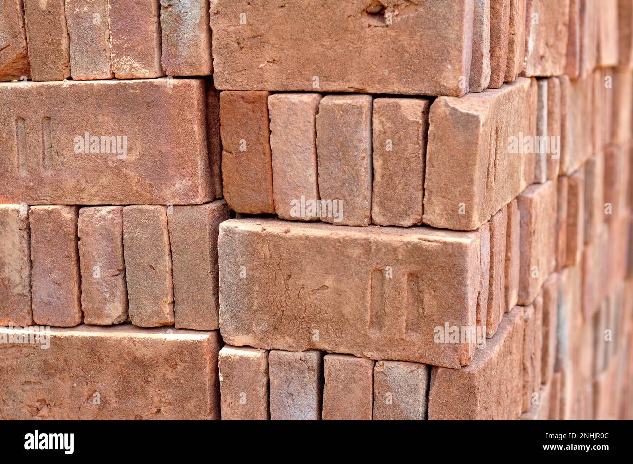 Pile of red bricks texture background Stock Photo - Alamy
