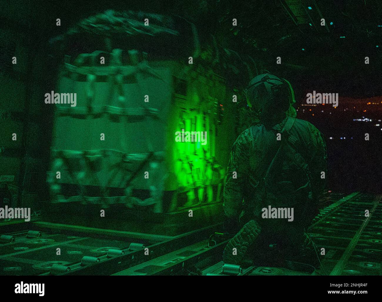 A U.S. Air Force HC-130J Combat King II aircraft drops airdrop pallets ...