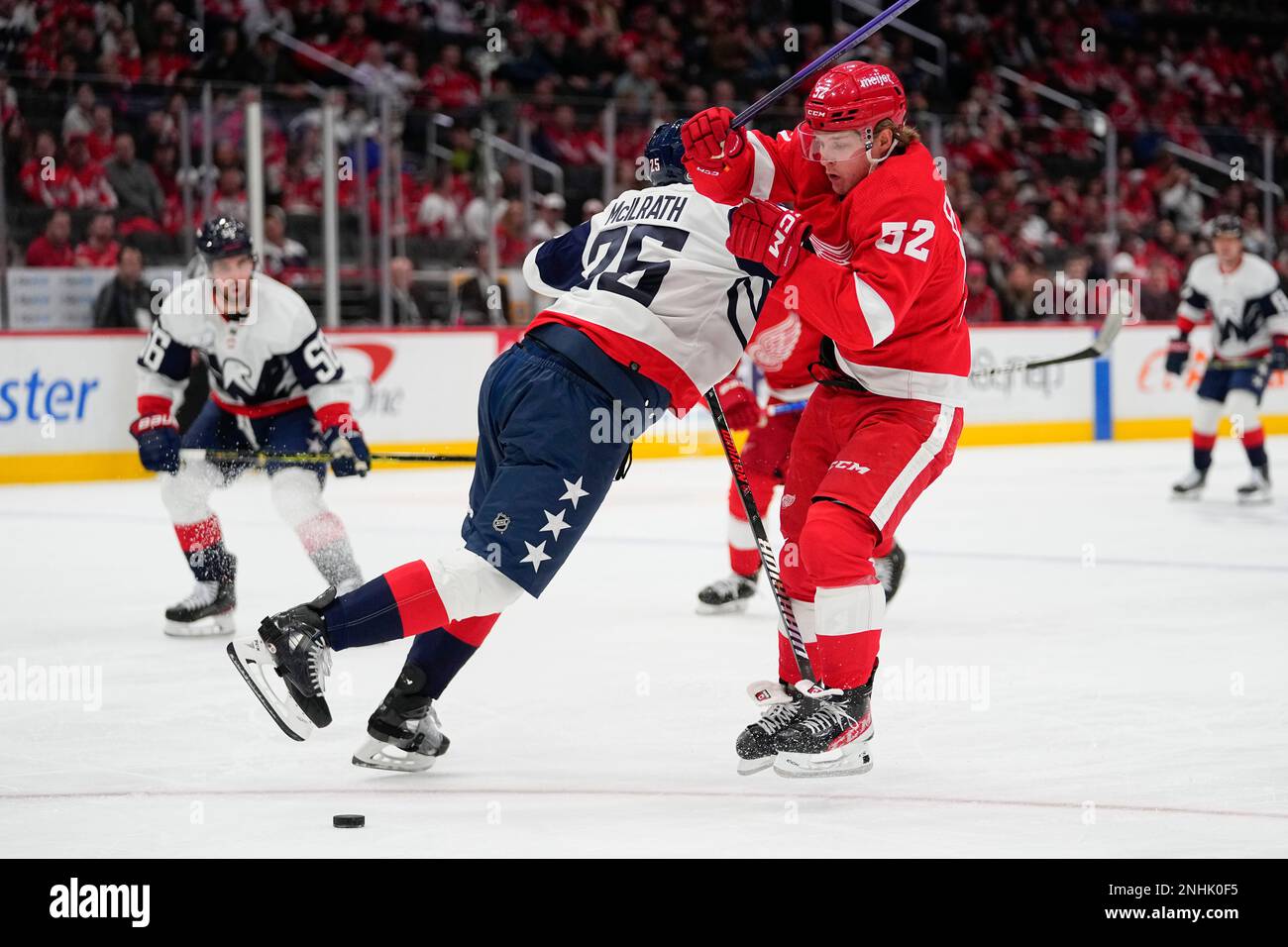 Washington Capitals defenseman Dylan McIlrath (25) applies a hit on ...