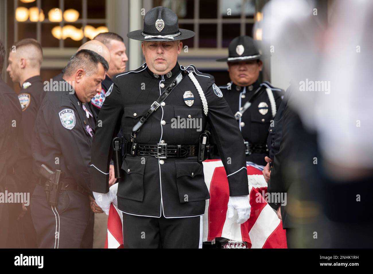 Honor guard officers carry the caskets of Bay St. Louis police officers Sgt. Steven Robin and ...