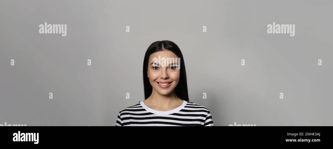 Portrait of happy young woman with beautiful black hair and charming ...