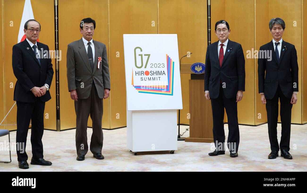 Japanese Prime Minister Fumio Kishida (2nd from R) unveils G7 2023 Hiroshima Summit logo ...