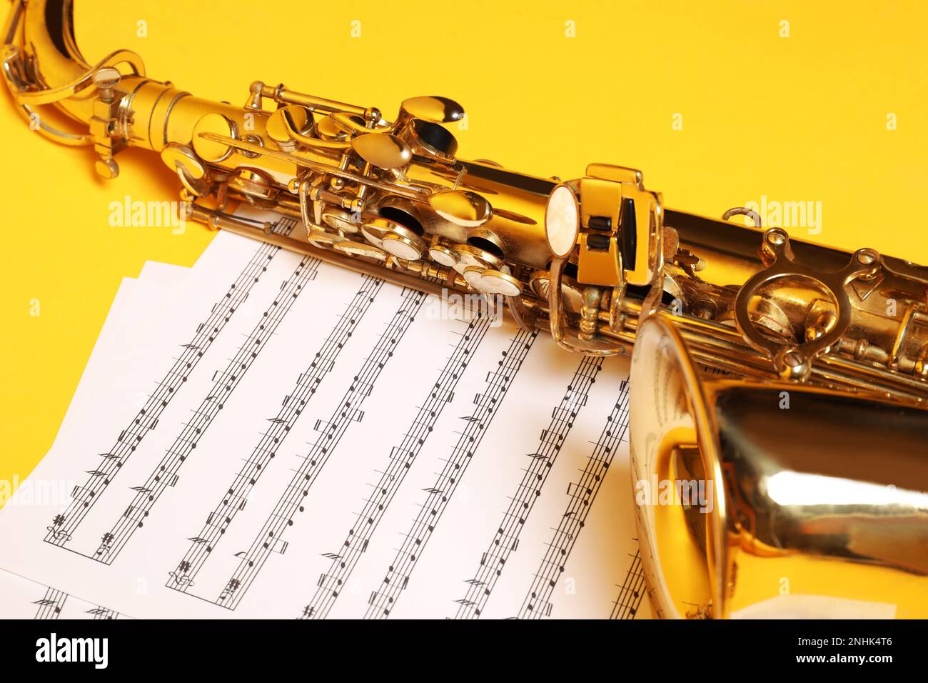 Beautiful saxophone and note sheets on yellow background, closeup Stock ...