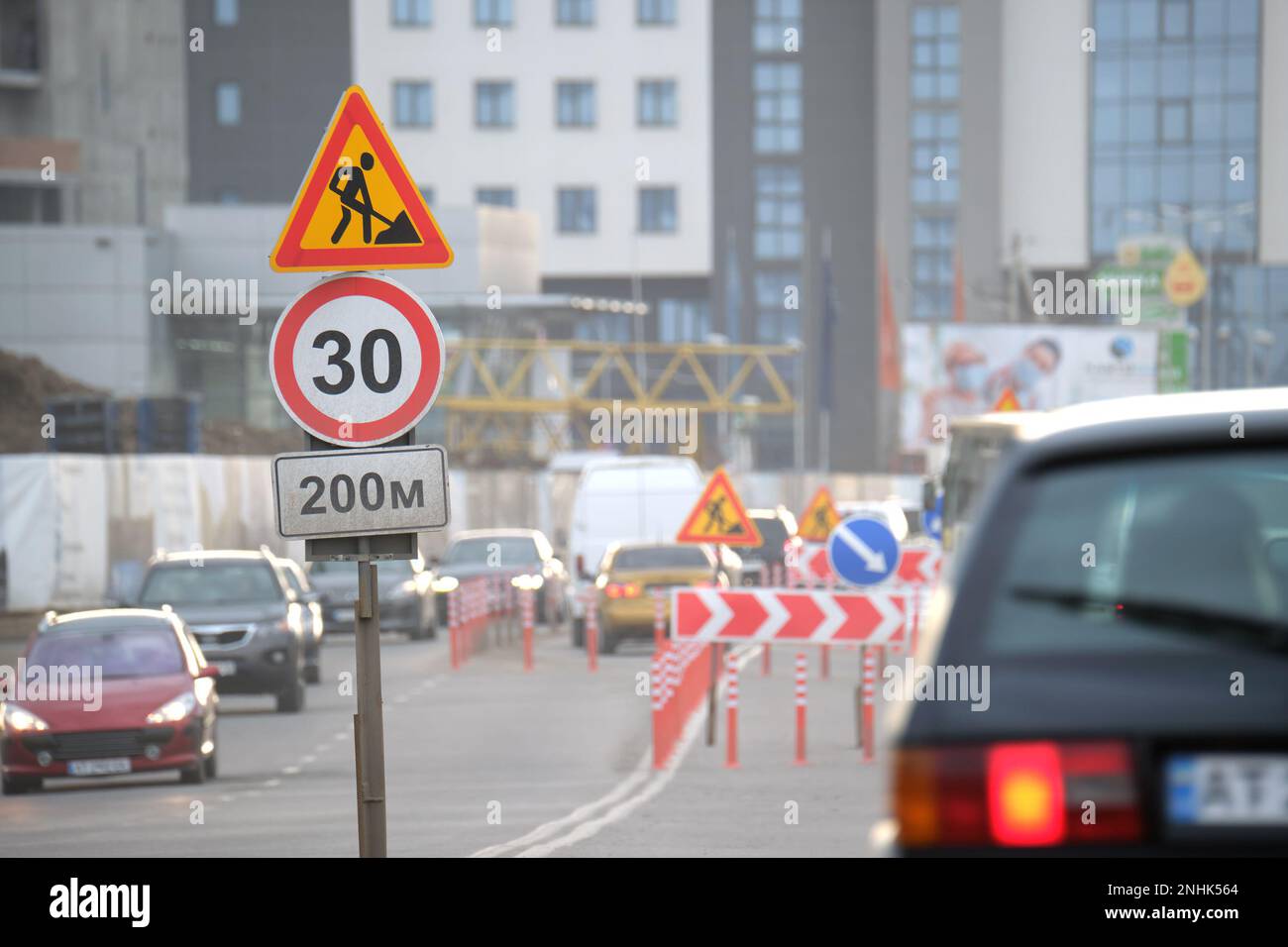 Roadworks warning traffic signs of construction work on city street and ...