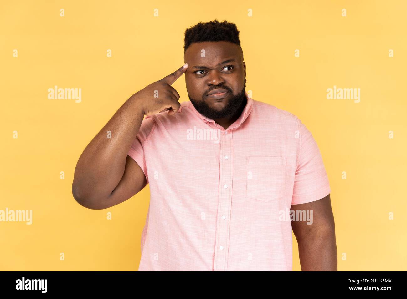 Crazy idea. Portrait of man in pink shirt showing stupid gesture ...