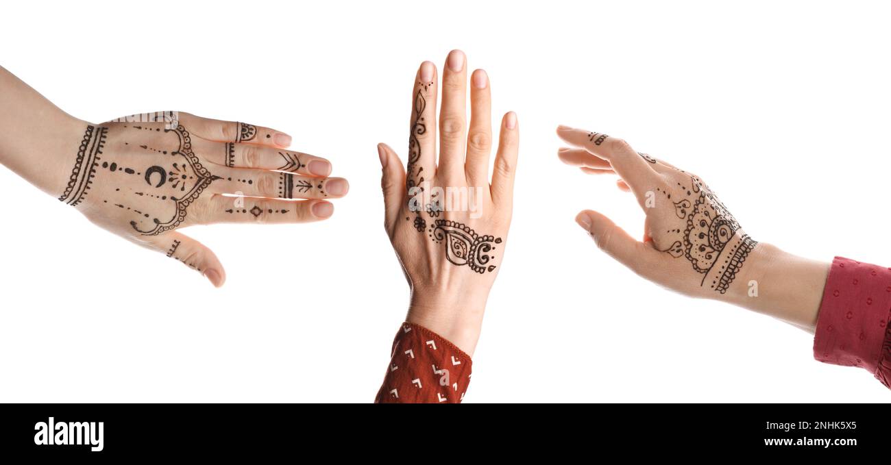 Closeup view of women with henna tattoo on hands against white ...