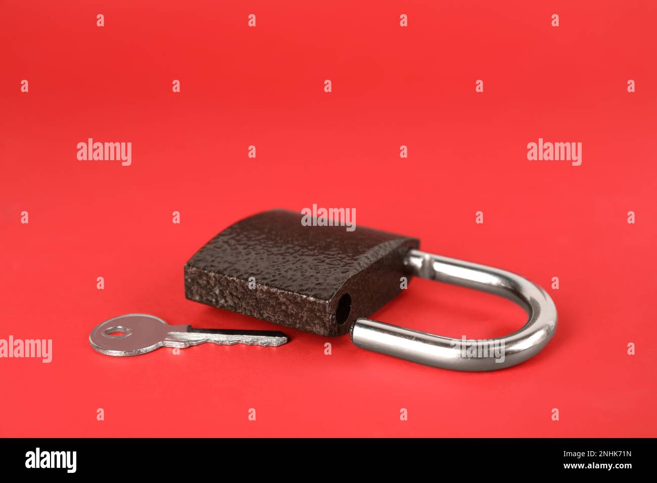 Modern padlock and key on red background. Space for text Stock Photo ...