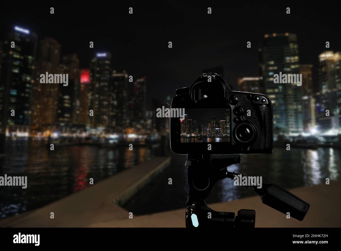 Night cityscape of marina district. Taking photo with camera mounted on ...