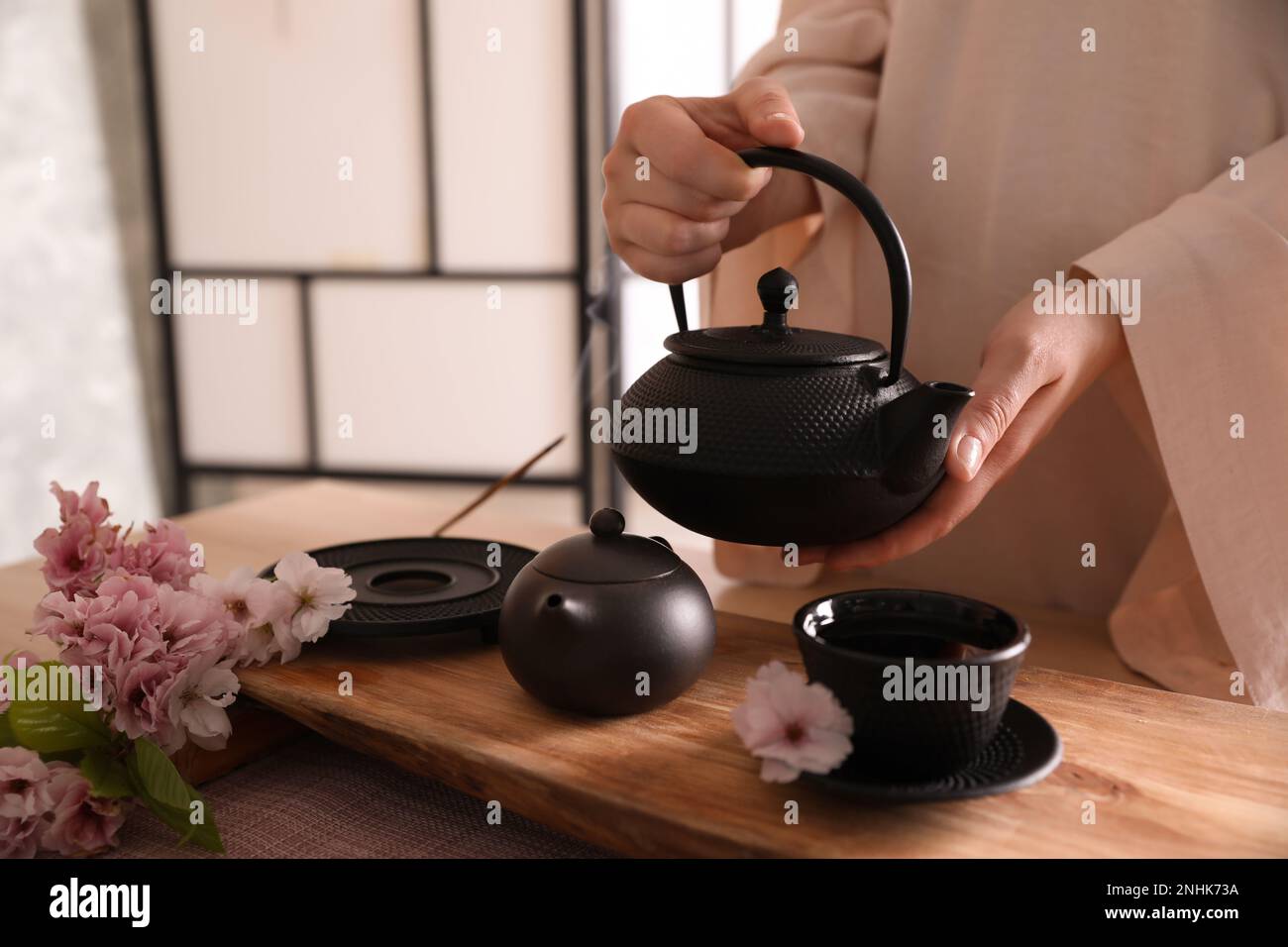 Master conducting traditional tea ceremony at table, closeup Stock ...