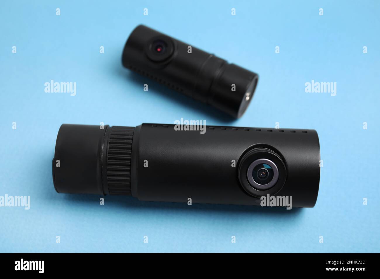 Black modern car cameras on turquoise background, closeup Stock Photo ...