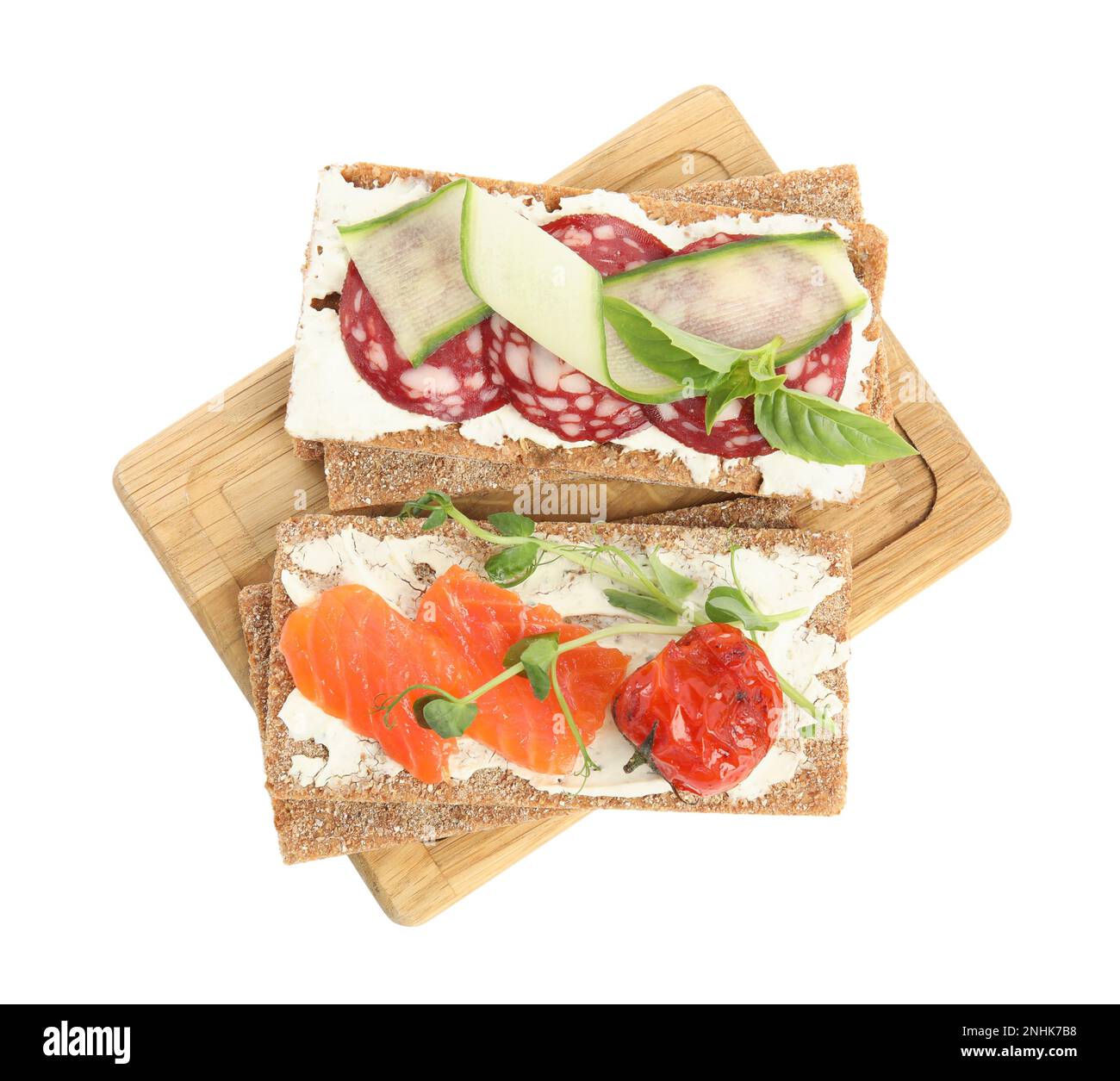 Fresh rye crispbreads with different toppings on white background, top ...