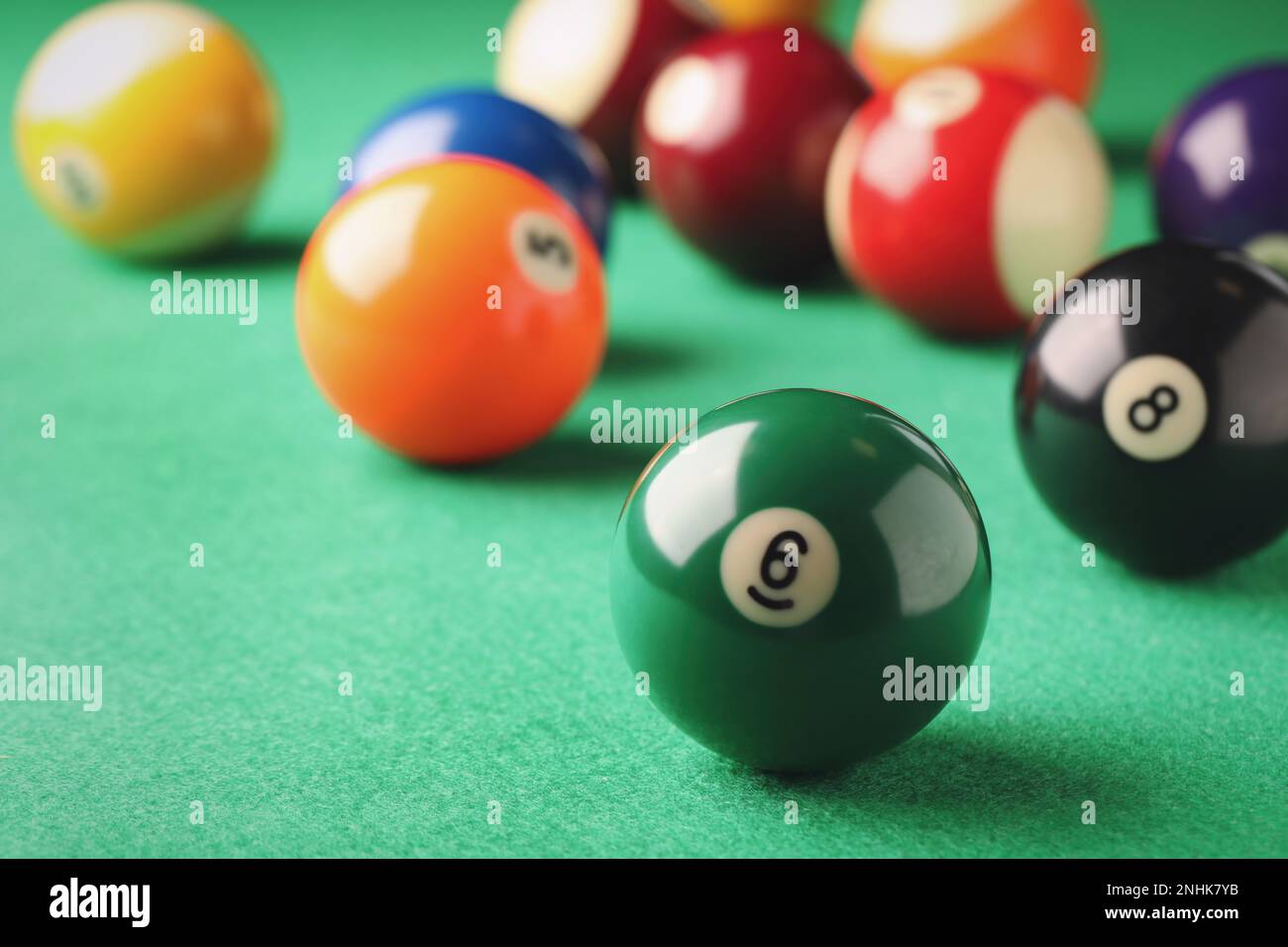 Billiard ball with number 6 on green table, closeup. Space for text ...