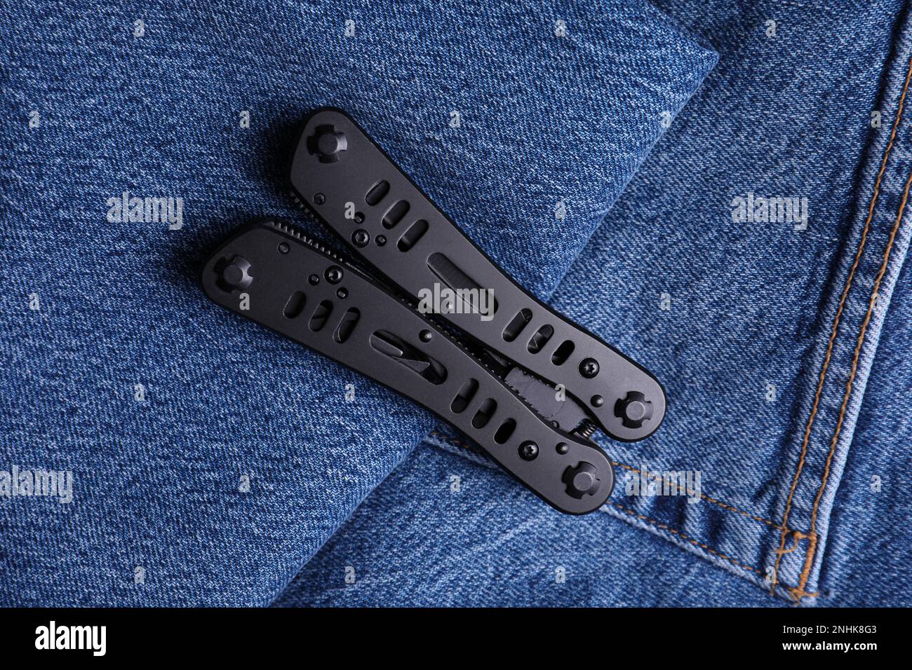 Modern compact portable multitool on denim fabric, top view Stock Photo ...