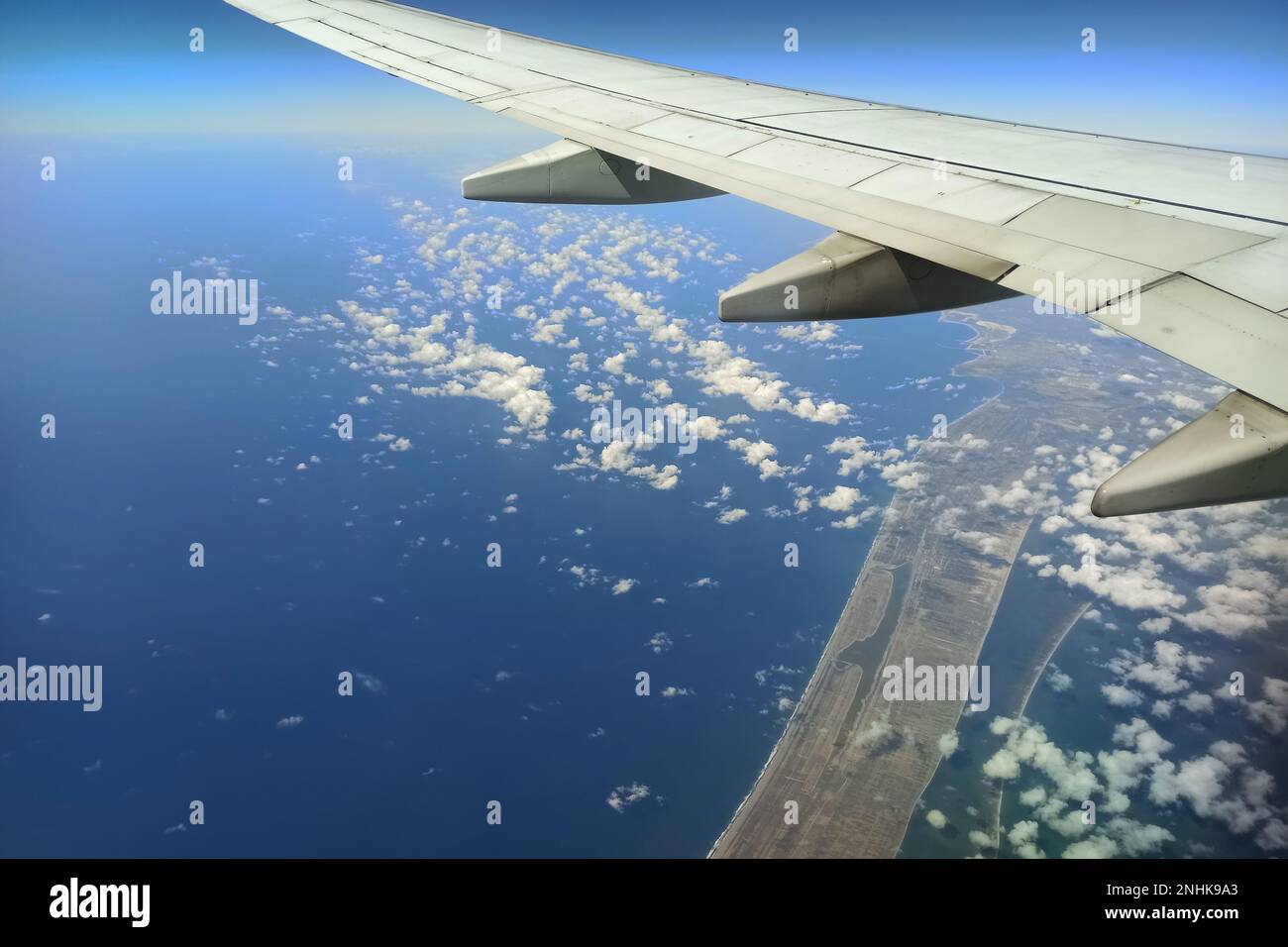View through airplane window of commercial jet plane wing flying high ...