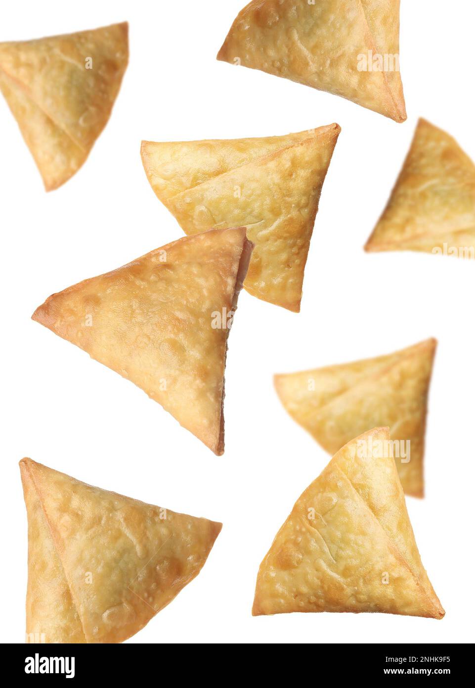 Crispy delicious samosas falling on white background Stock Photo - Alamy