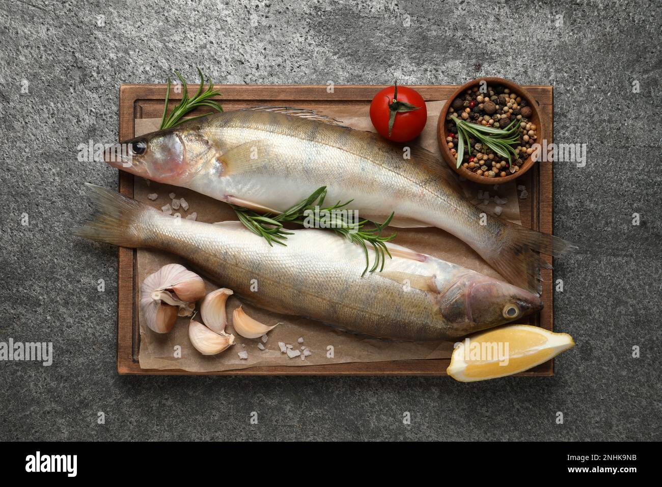 Fresh raw pike perches and ingredients on grey table, top view. River ...
