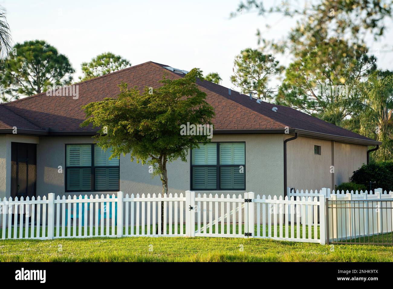 White plastic fence for back yard protection and privacy Stock Photo - Alamy