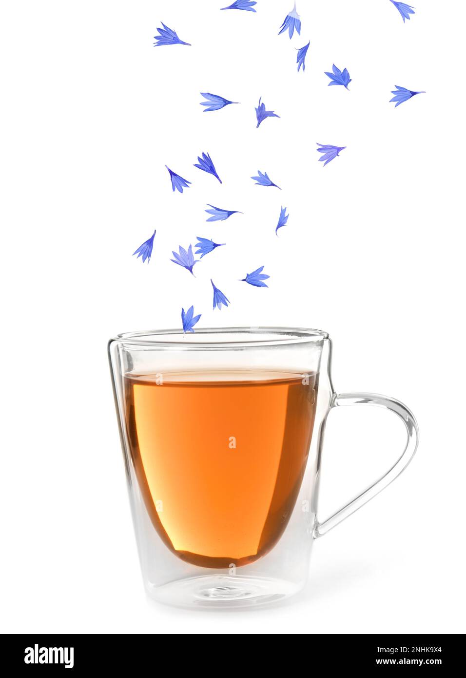 Beautiful tender blue cornflower petals falling into cup of tea on ...