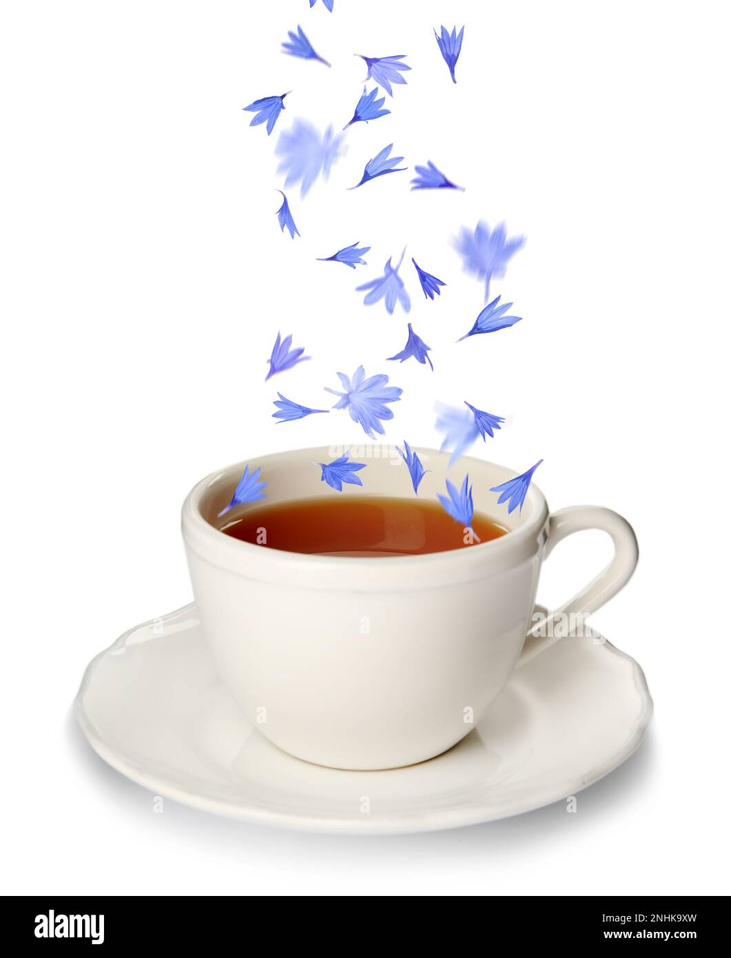 Beautiful tender blue cornflower petals falling into cup of tea on ...