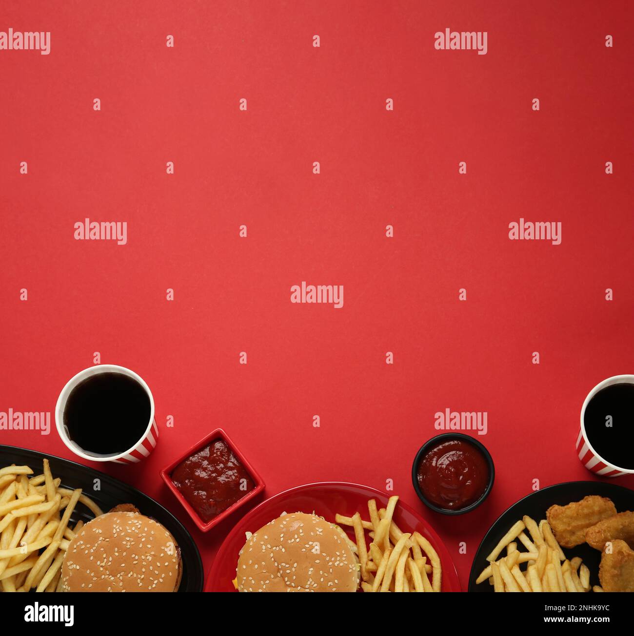 Different fast food on red background, flat lay. Space for text Stock ...