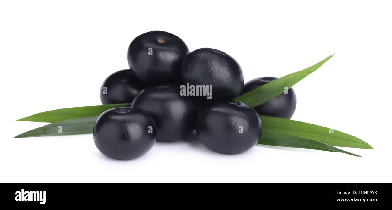Pile of fresh ripe acai berries and green leaves on white background ...
