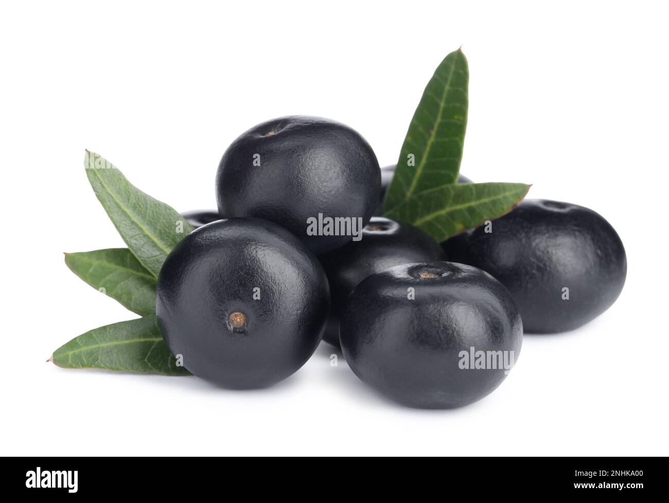 Pile of fresh ripe acai berries and green leaves on white background ...