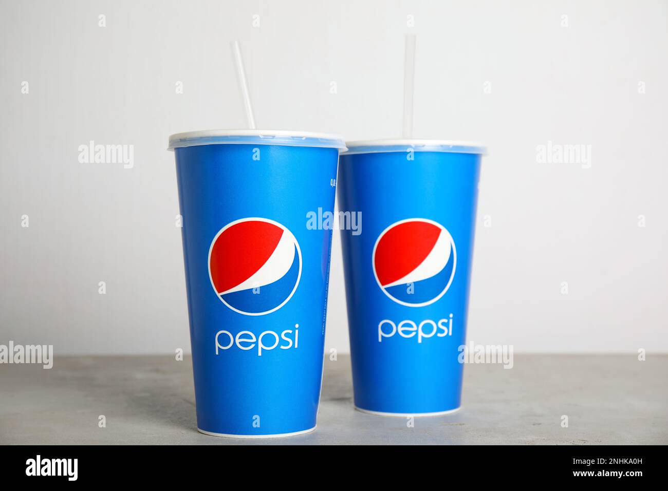 MYKOLAIV, UKRAINE - JUNE 9, 2021: Paper Pepsi cups on light grey table ...