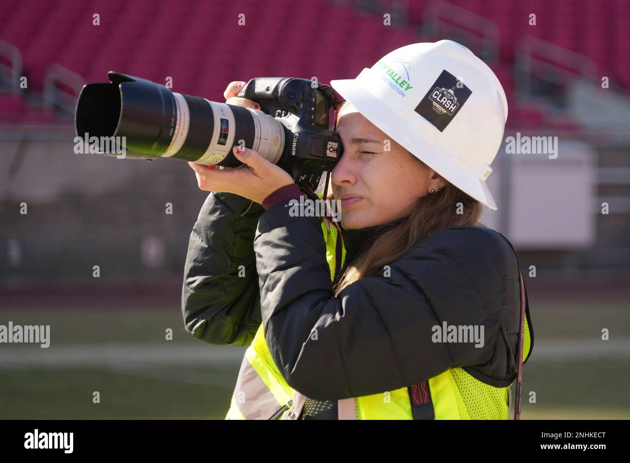Female press photographer Meg Oliphant takes photos wearing a hard hat ...