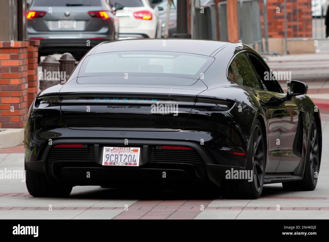 USC quarterback Caleb Williams drives a Porsche Taycan elective vehicle ...