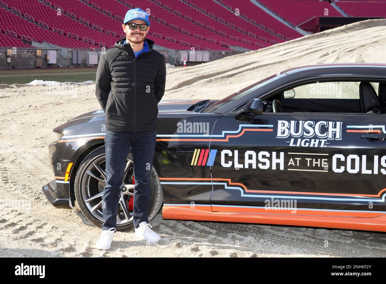 Kyle Larson poses with Chevrolet pace car during 2023 Busch Light Clash ...
