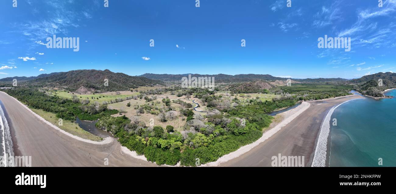 Lush Tropical coastline with rocks and blue water in Costa Rica near ...