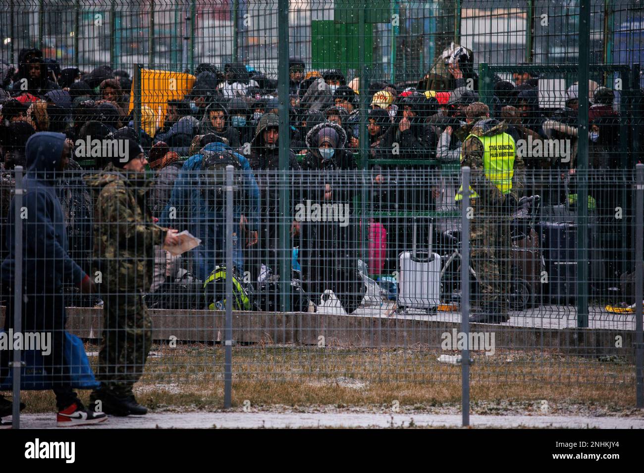 EP- 2022 photos selection: People wait behind a gate to enter Poland at ...