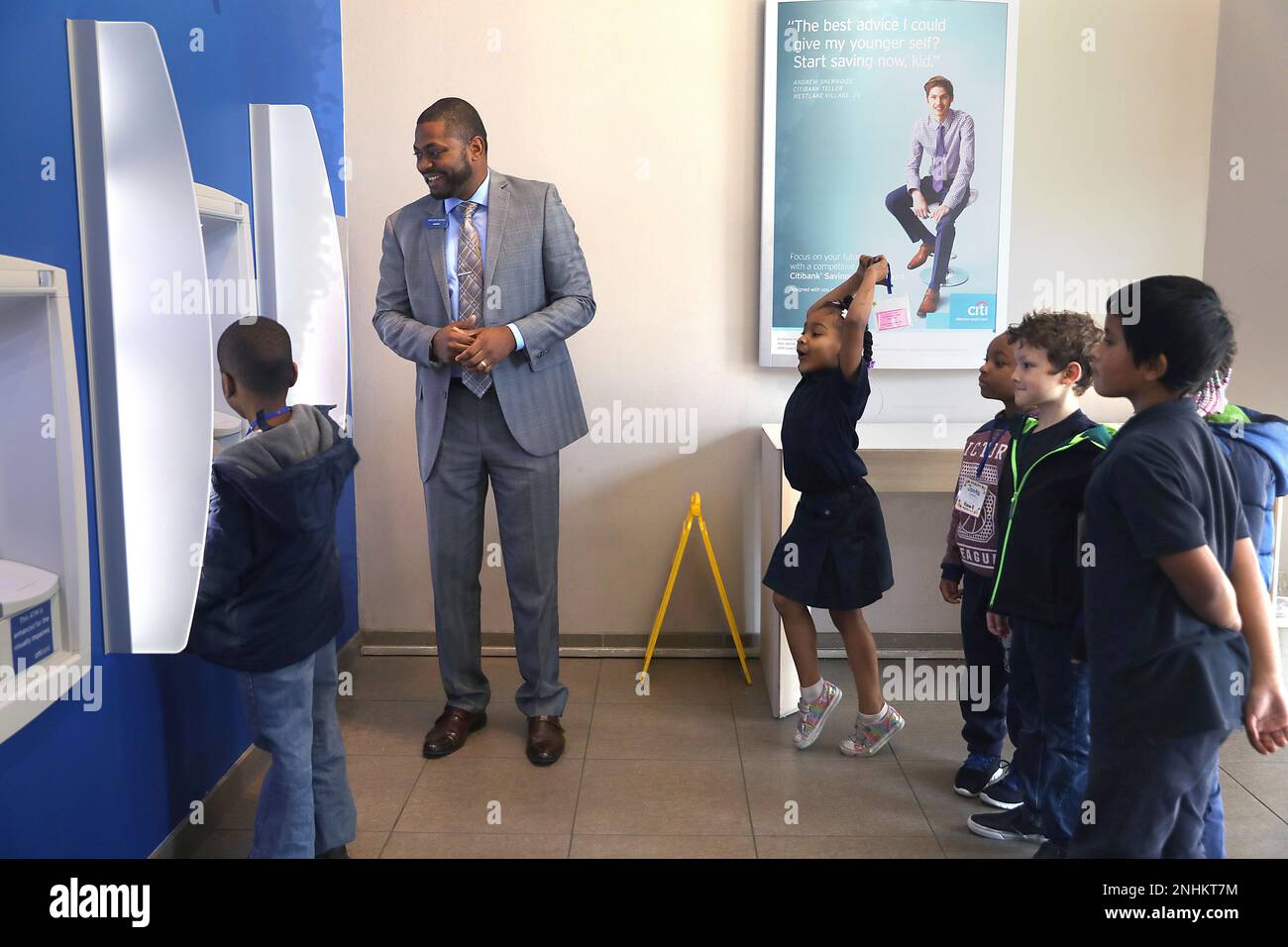 Citibank branch manager Gregory George shows first graders from Cobb ...