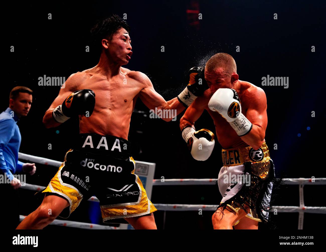 Naoya Inoue (L), Japanese three-division bantamweight champion, delivers his punch against ...