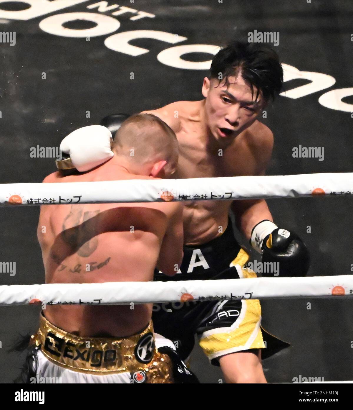 Naoya Inoue (R), Japanese three-division bantamweight champion, delivers his punch against ...