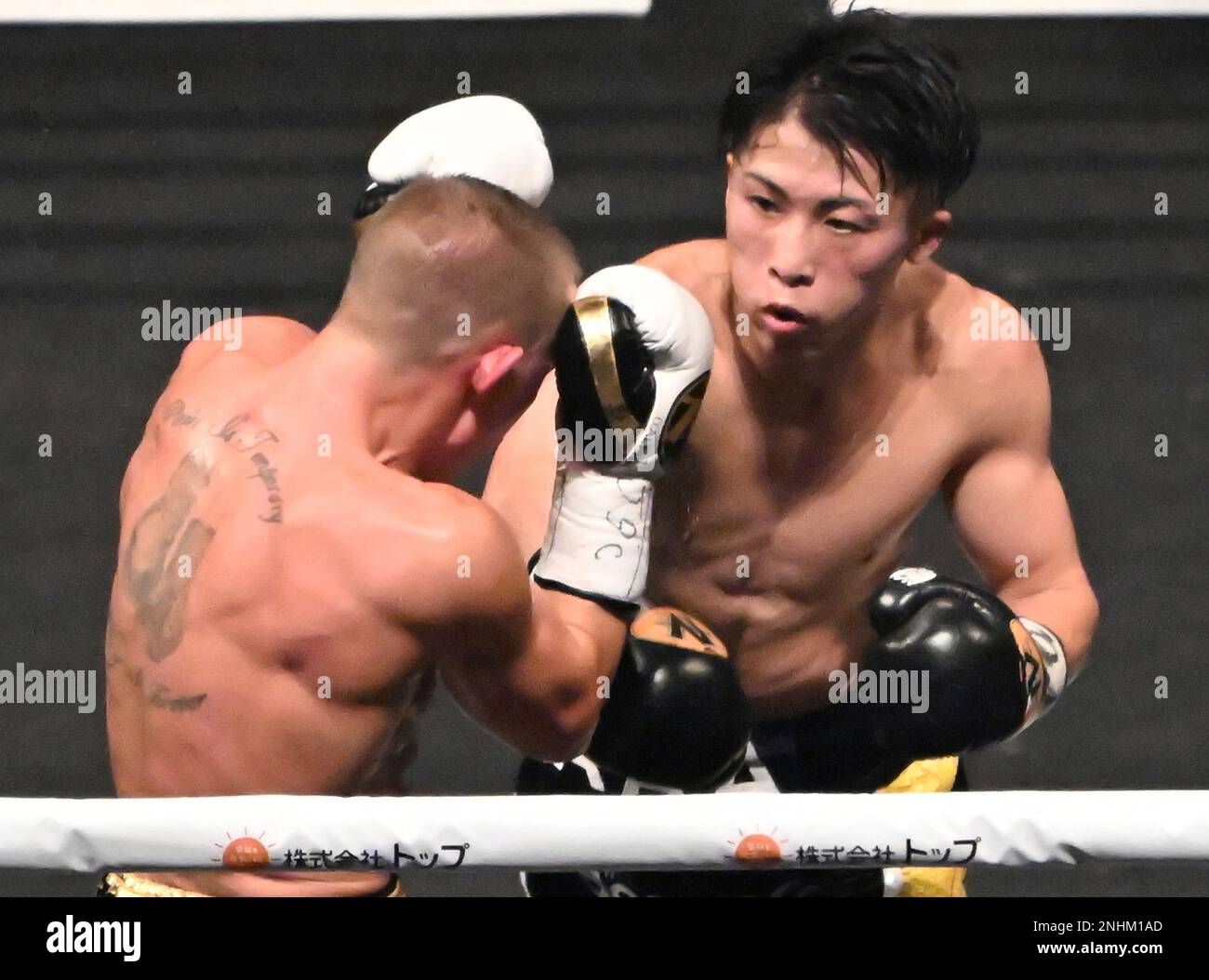 Naoya Inoue (R), Japanese three-division bantamweight champion, delivers his punch against ...