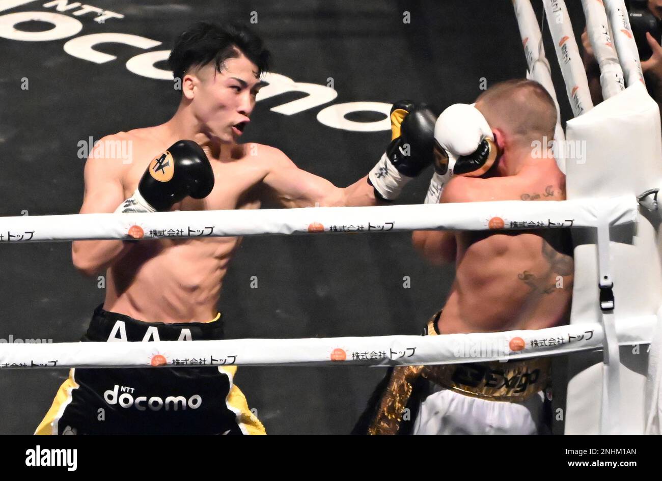 Naoya Inoue (L), Japanese three-division bantamweight champion, delivers his punch against ...