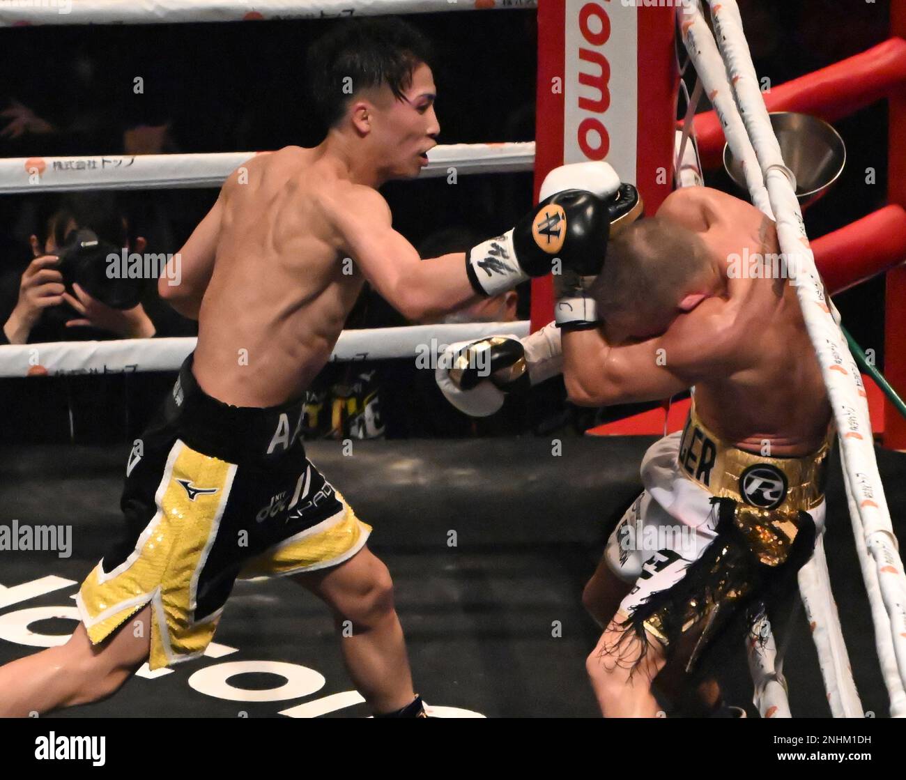 Naoya Inoue (L) Japanese three-division bantamweight champion, delivers his punch against ...