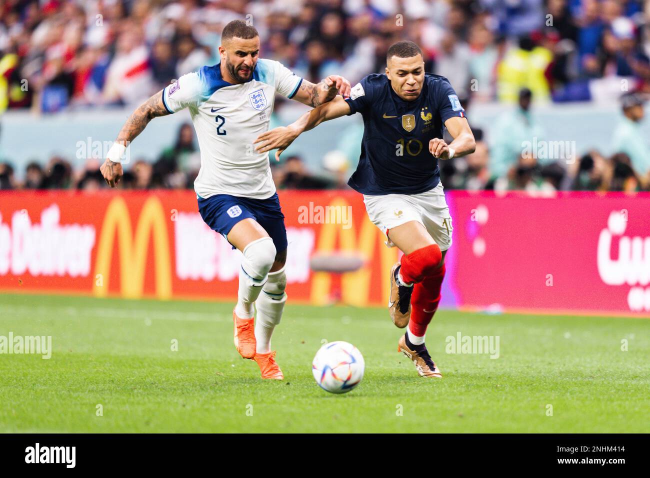 AL KHOR, QATAR - DECEMBER 10: France forward Kylian Mbappe dribbles past England defender Kyle ...