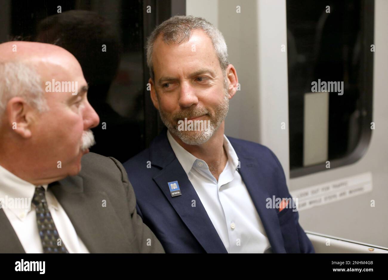 New Muni director Jeffrey Tumlin (right) chats with a passenger on Muni ...