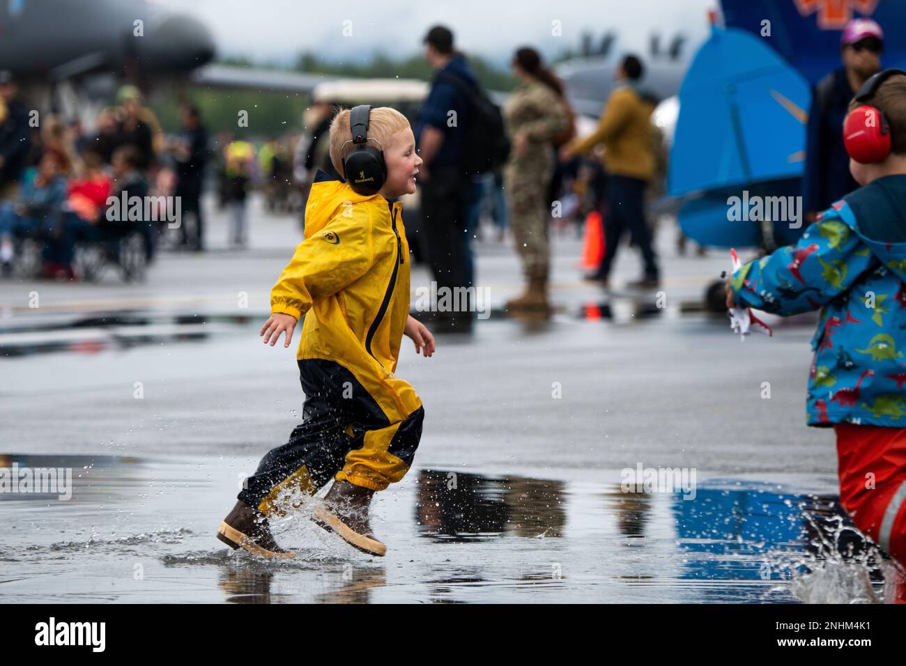 A child plays in a puddle at the Arctic Thunder Open House at Joint ...