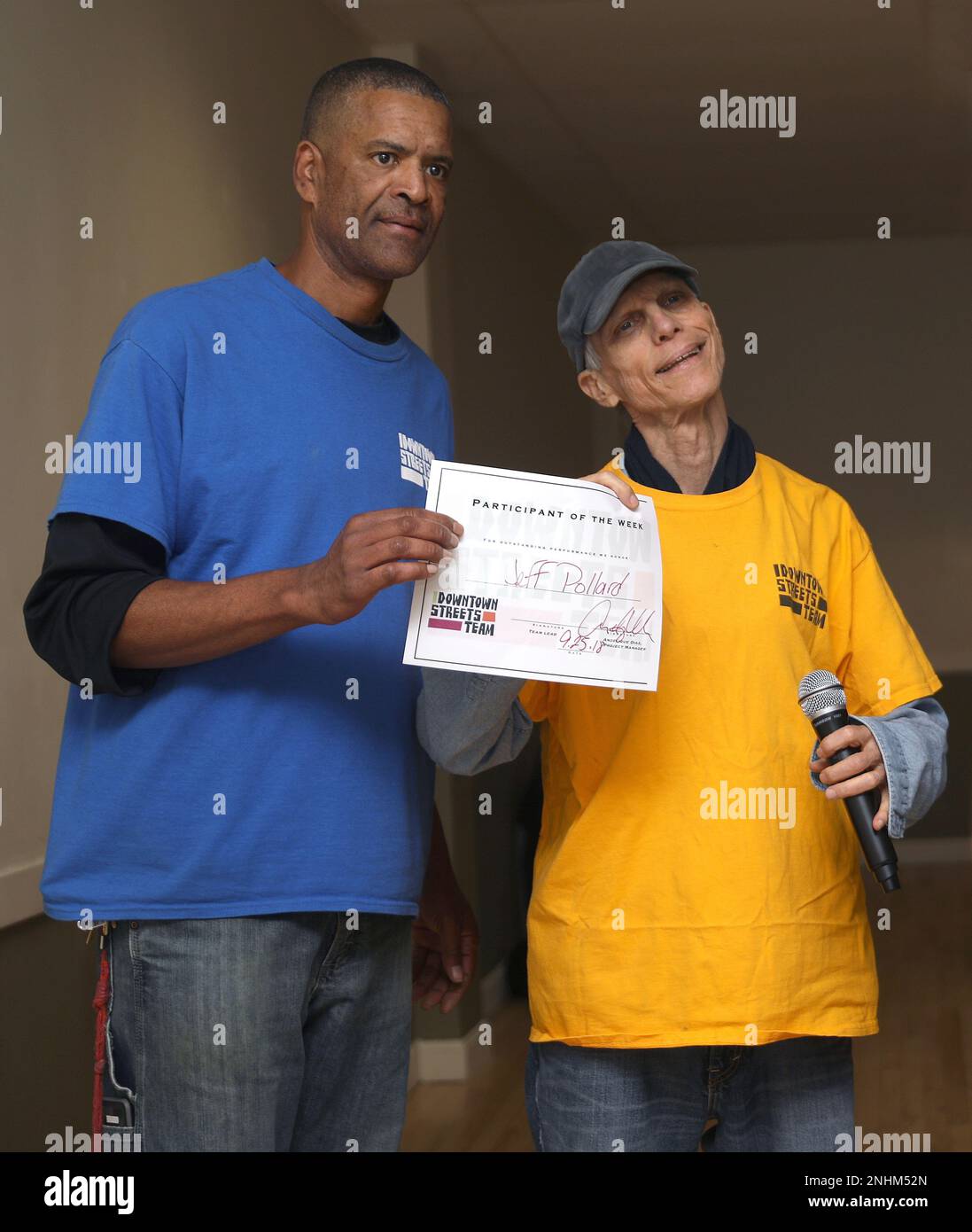 Jeff Pollard (right) receives a certificate for outstanding work ...