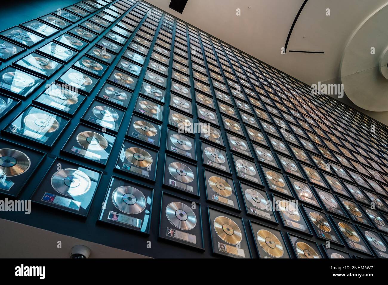 gold and silver records hanging on a wall at country music hall of fame ...