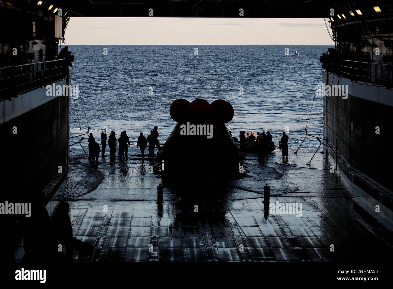 A U.S. Navy dive team returns to the well deck after successfully ...