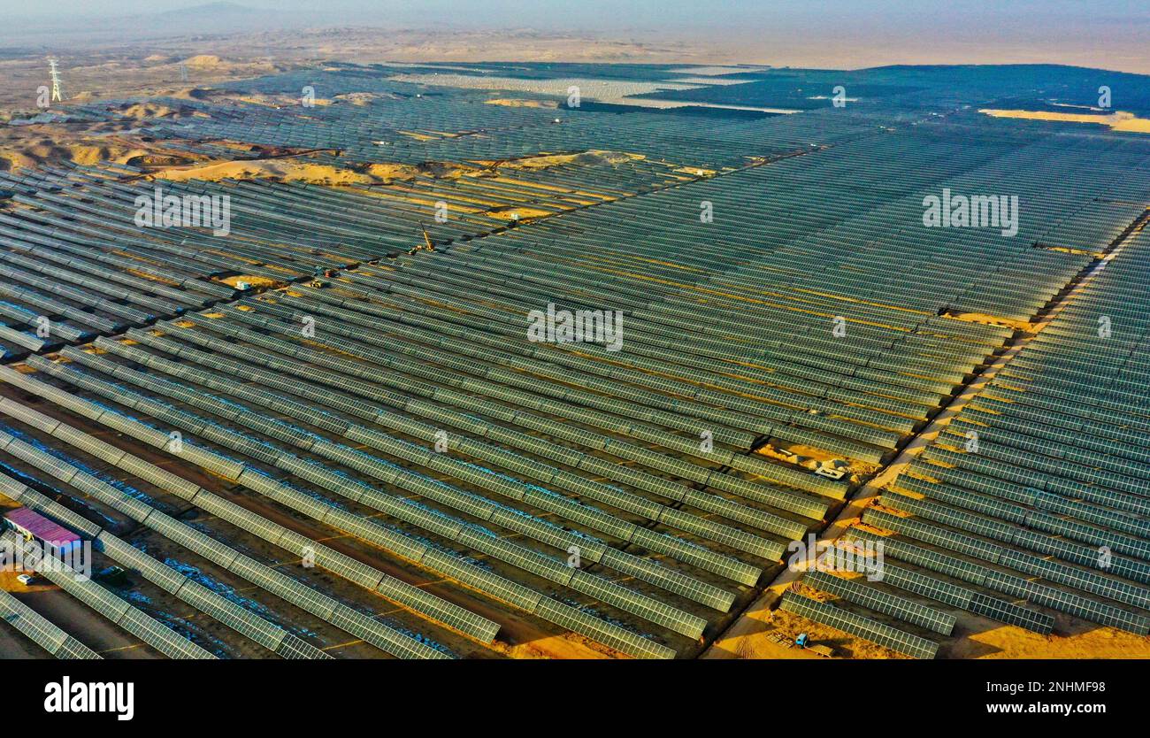 An aerial view of a solar power plant under construction in the desert ...